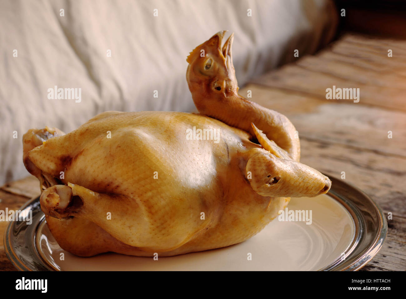 Chicken on a plate with wooden table Stock Photo - Alamy