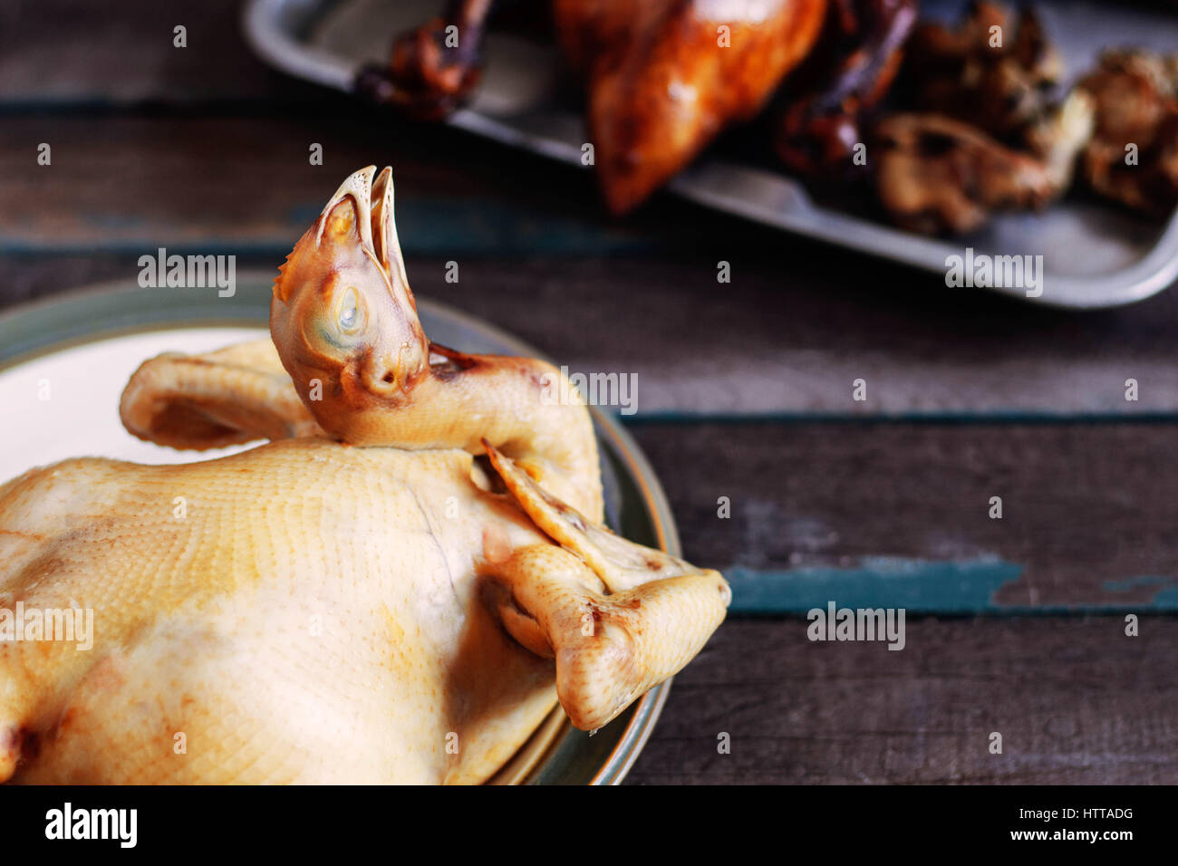 Roasted chicken on a plate with wooden tables Stock Photo - Alamy