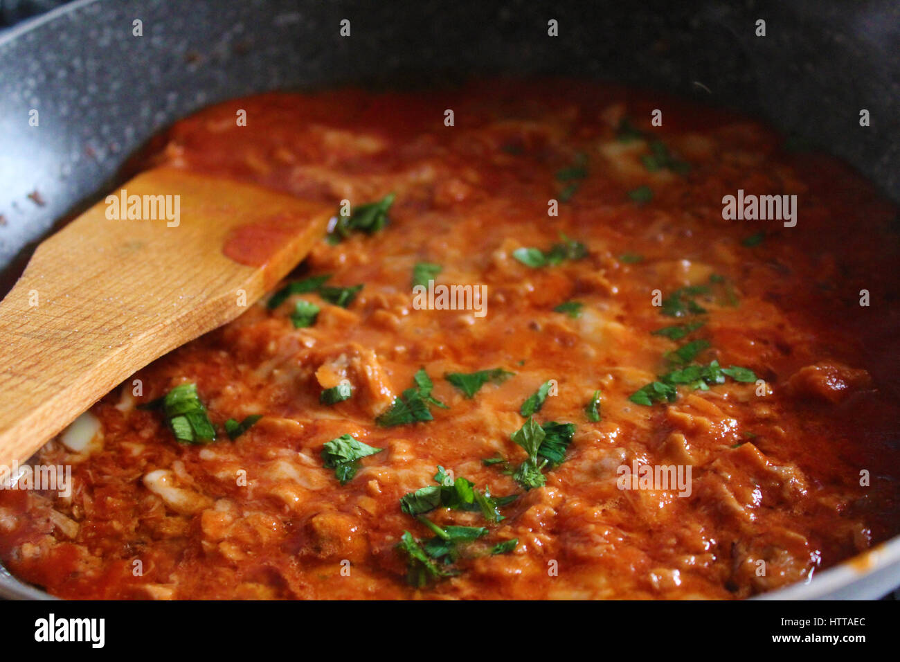 Cooking sauce with meat in frying pan Stock Photo - Alamy