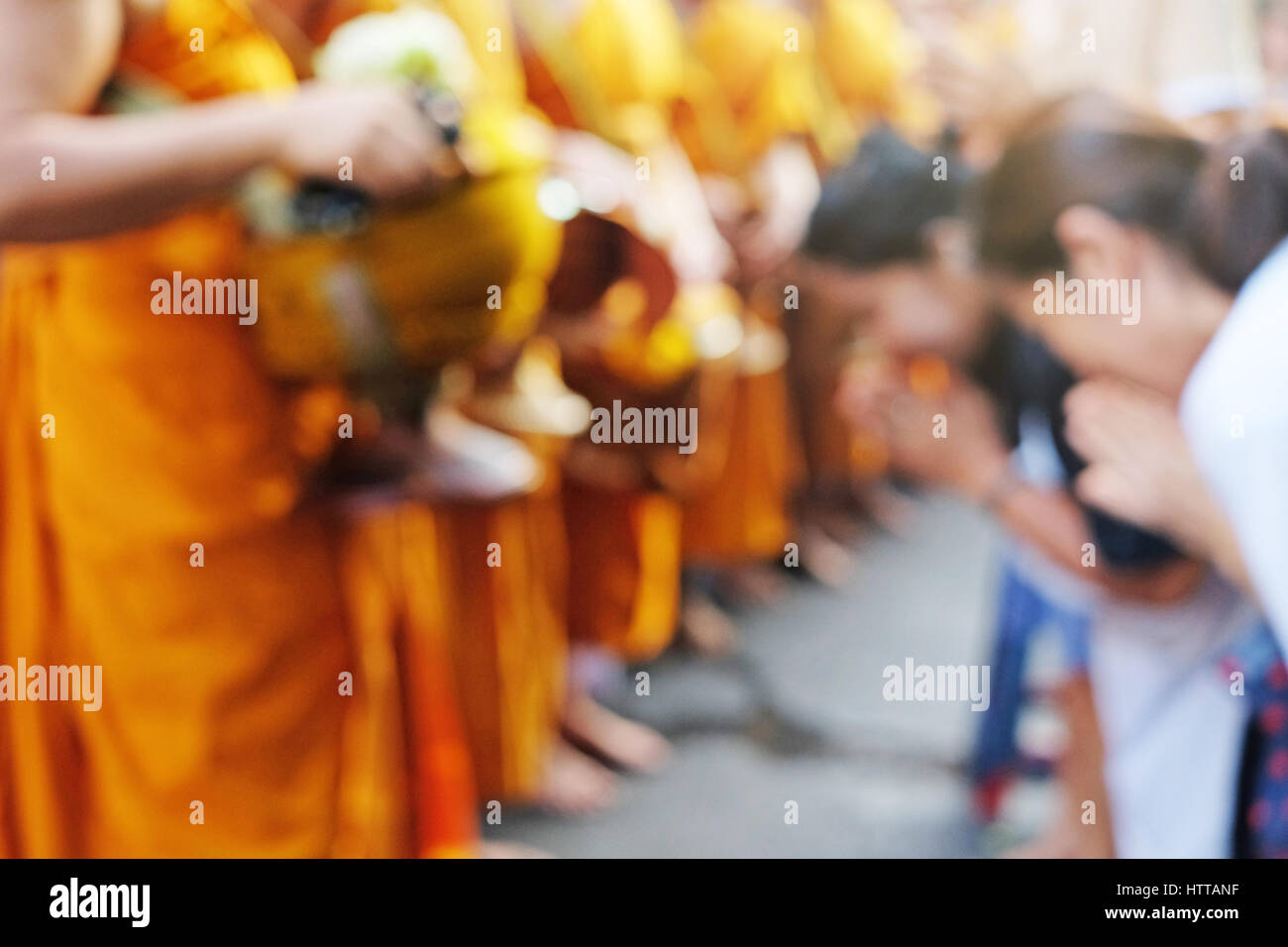 give alms to monk blur background Stock Photo - Alamy