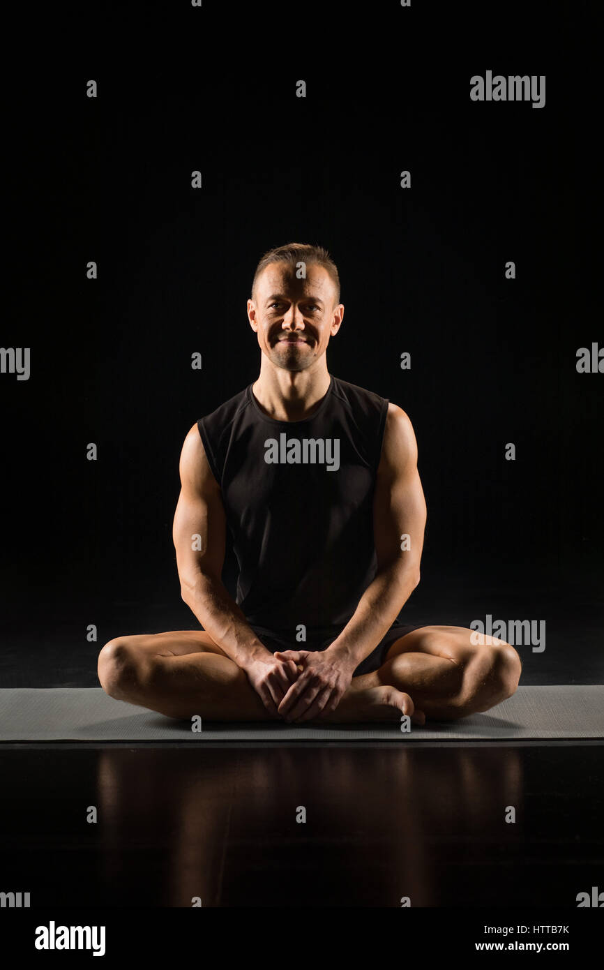 Man sitting in lotus position Stock Photo - Alamy