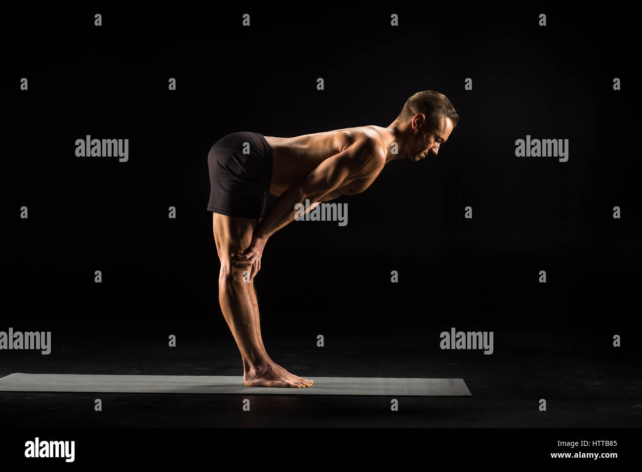 Man standing in yoga position Stock Photo - Alamy