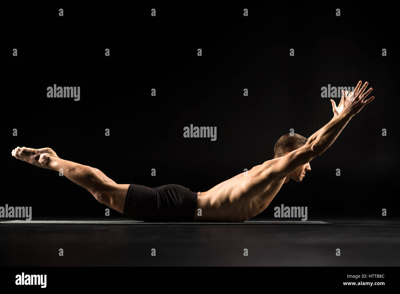 Man lying in yoga position Stock Photo - Alamy