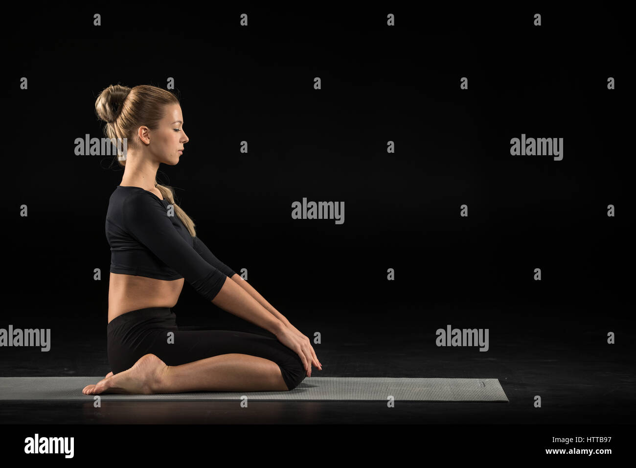 Woman sitting in yoga position Stock Photo - Alamy