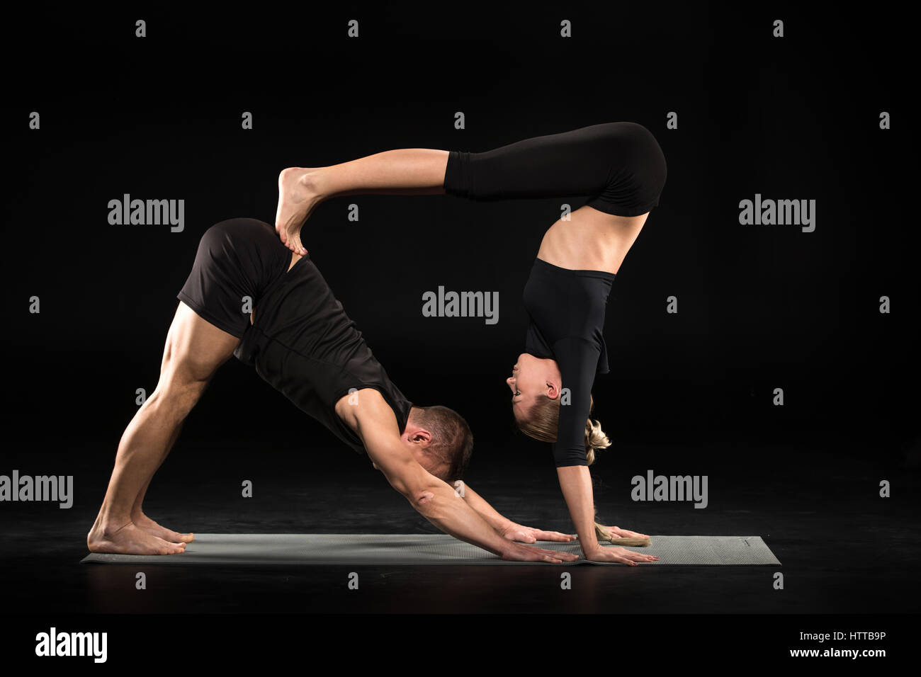 Couple performing acroyoga Stock Photo - Alamy