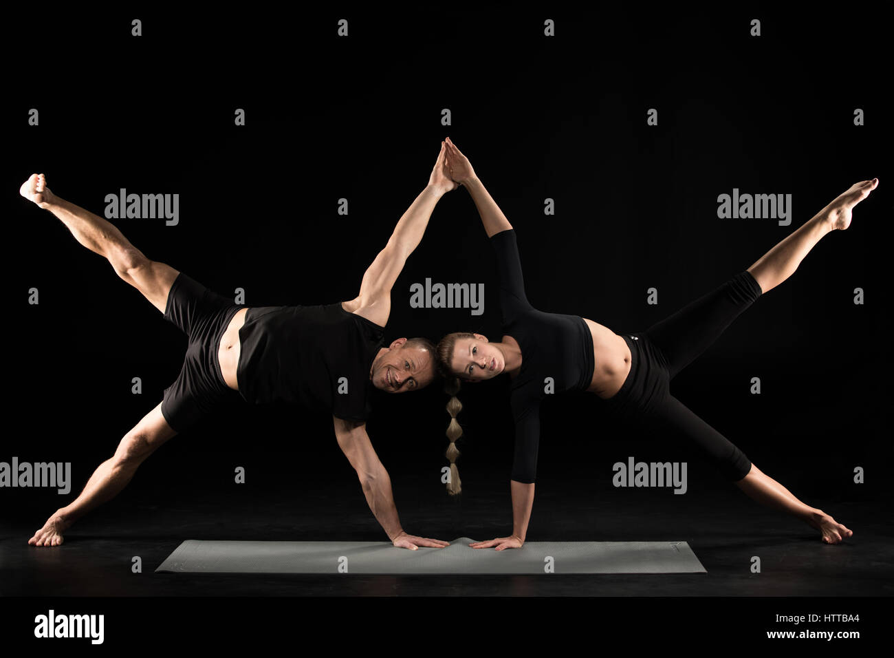 Couple performing acroyoga Stock Photo - Alamy