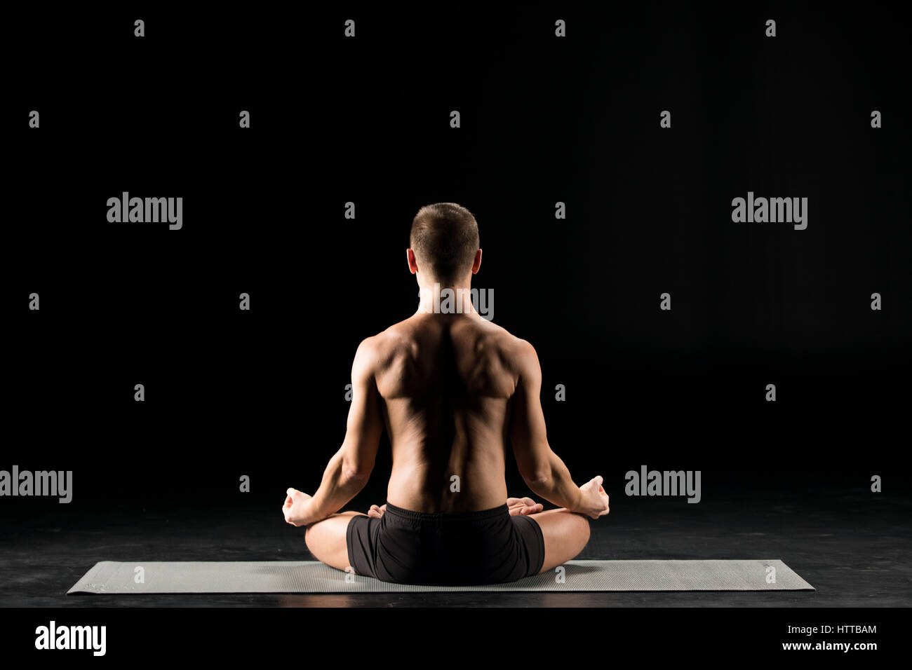 Man sitting in lotus position Stock Photo - Alamy