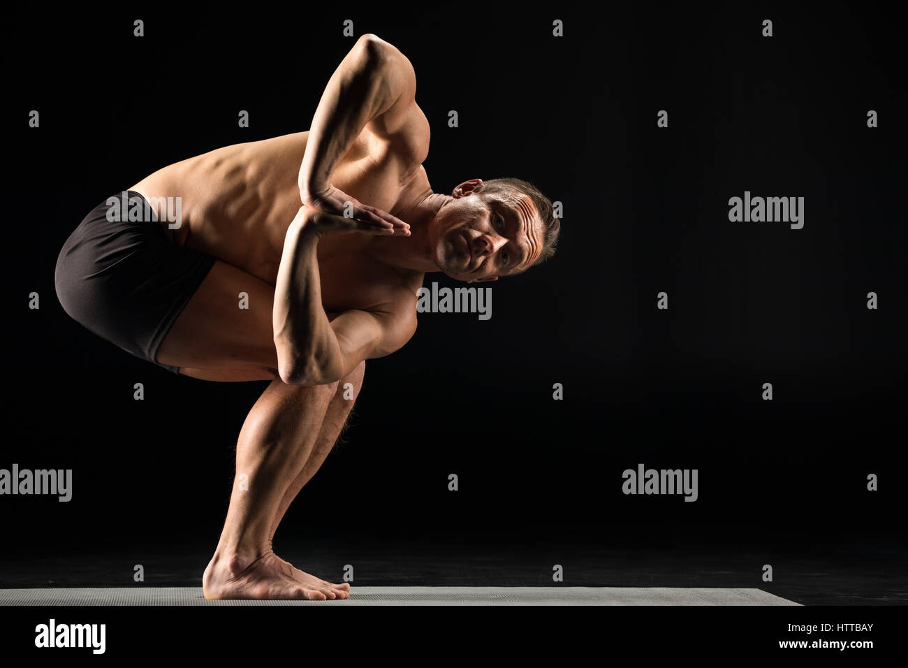 Man standing in yoga position Stock Photo - Alamy