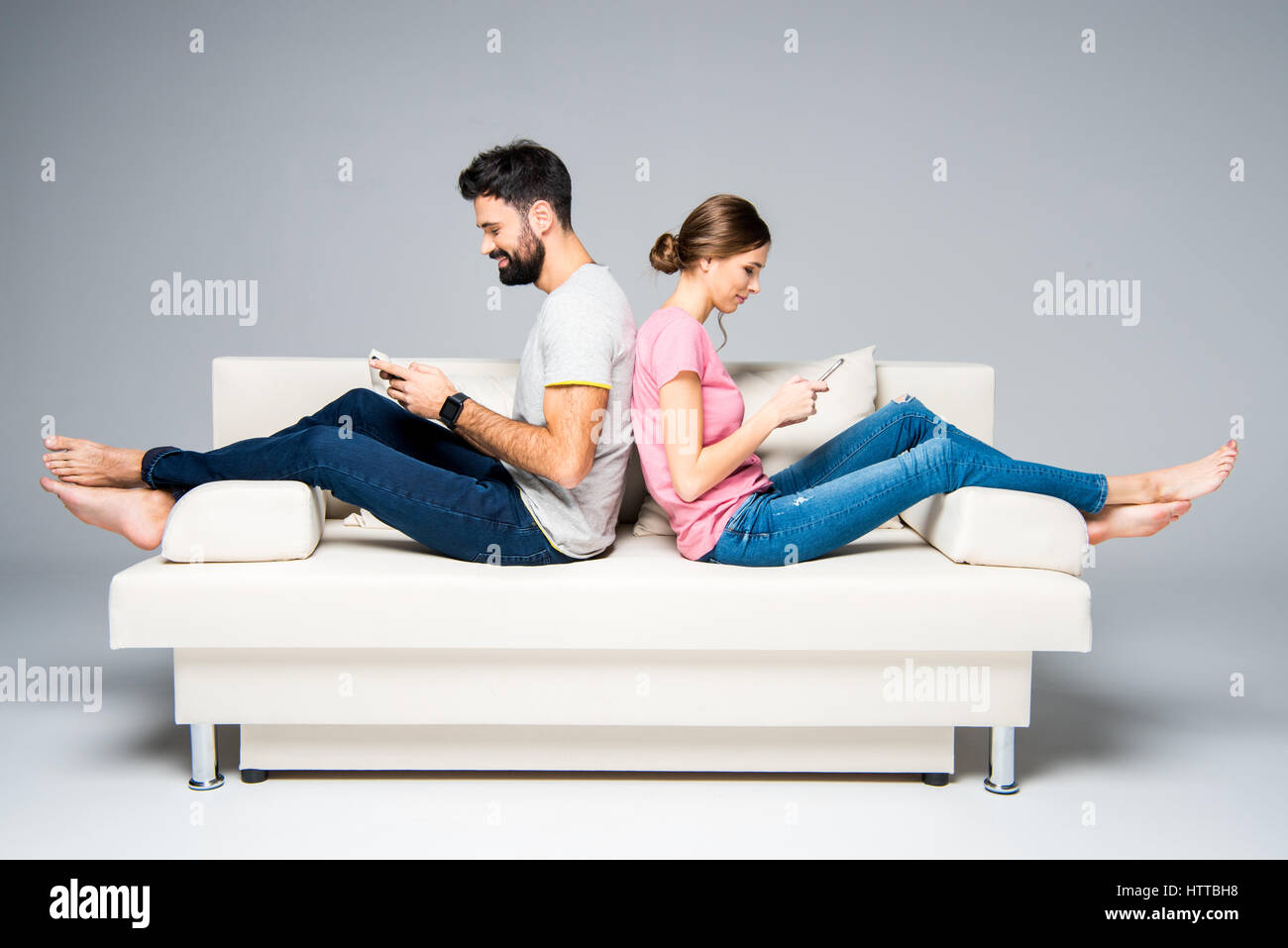Couple using smartphones Stock Photo - Alamy