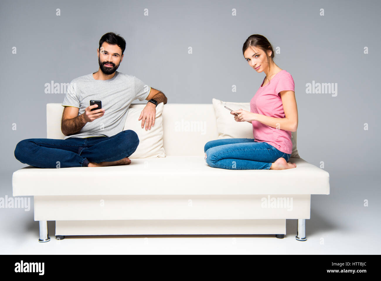 Couple using smartphones Stock Photo - Alamy
