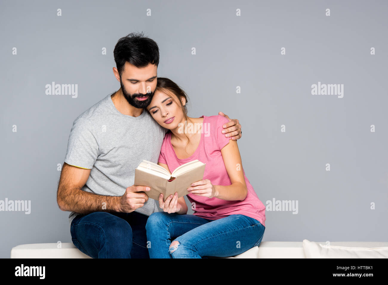 Couple reading book Stock Photo - Alamy