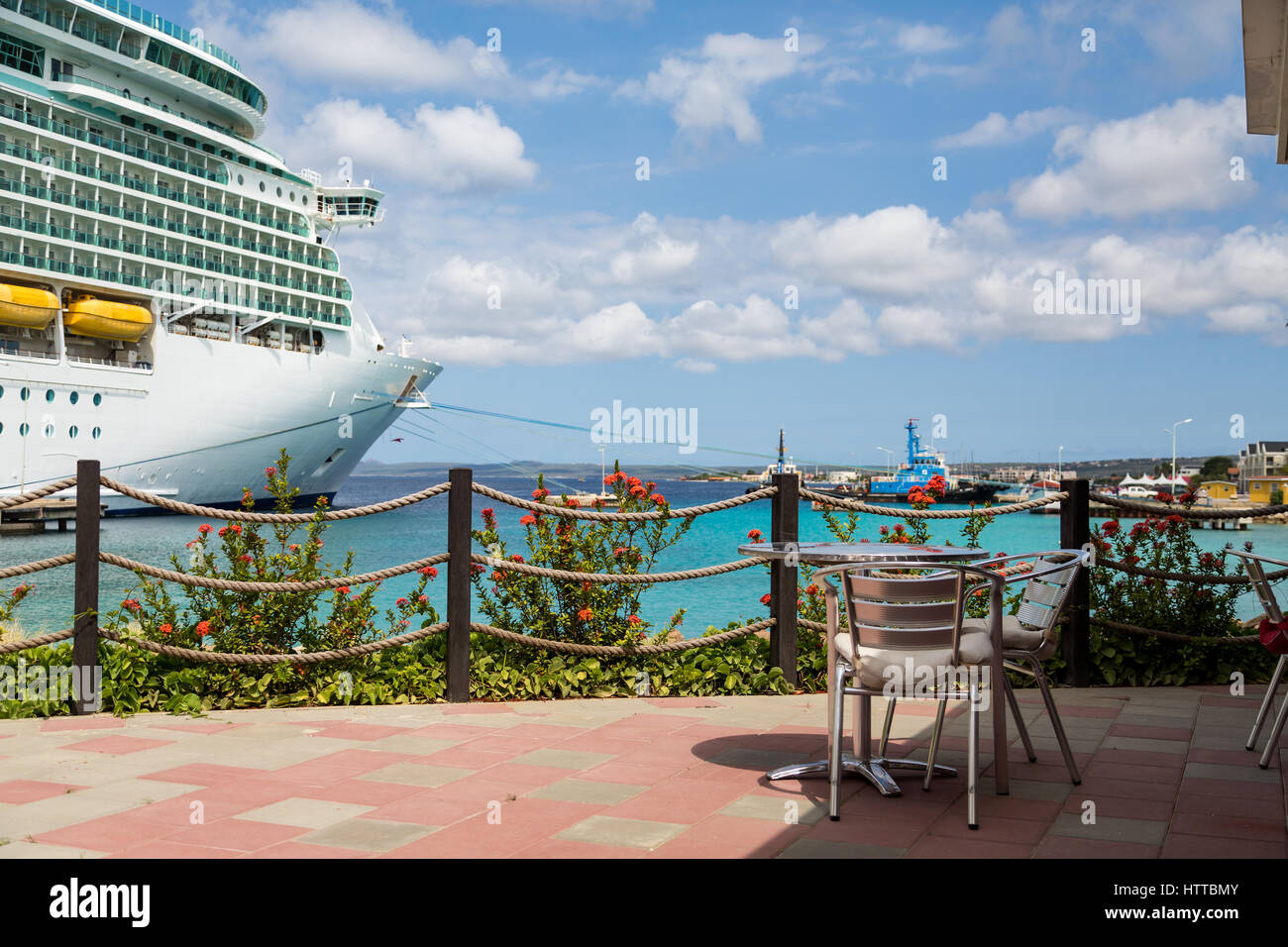 Table on patio of a coastal Caribbean restaurant with a luxury cruise ...