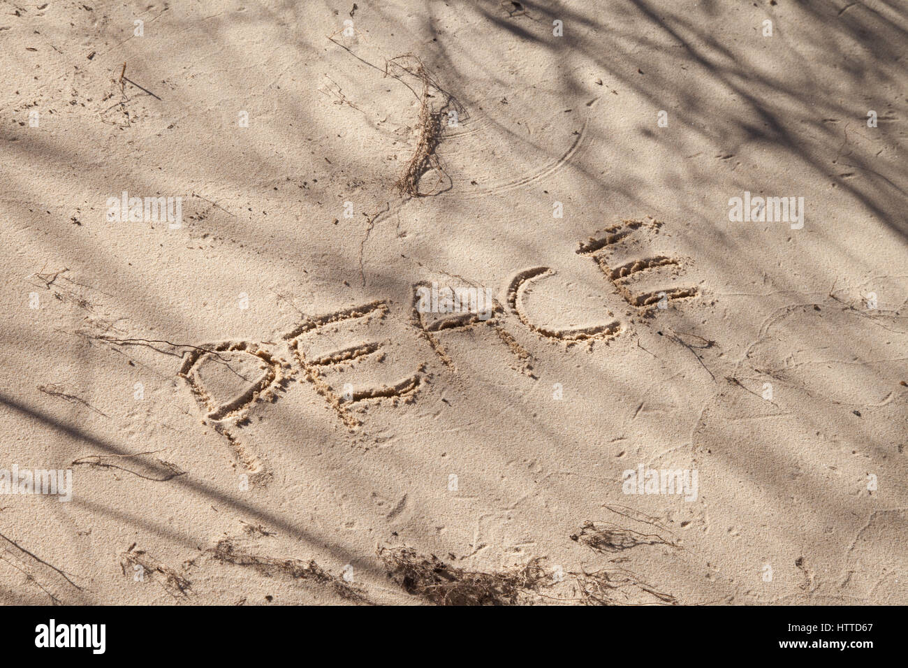 The word Peace written in sand on the beach Stock Photo - Alamy