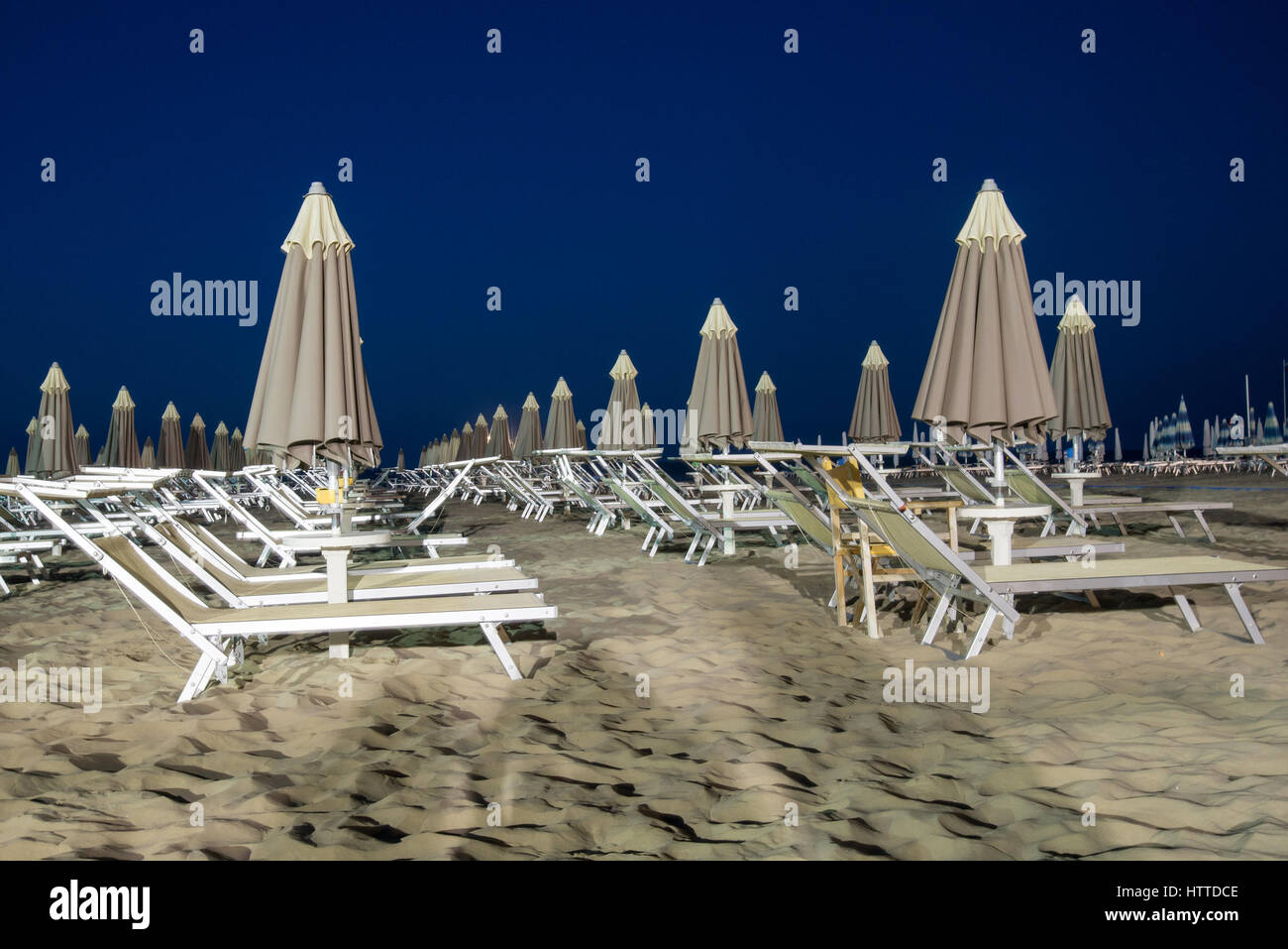 Deserted beach in the night. Empty sunbeds. Beach without people ...