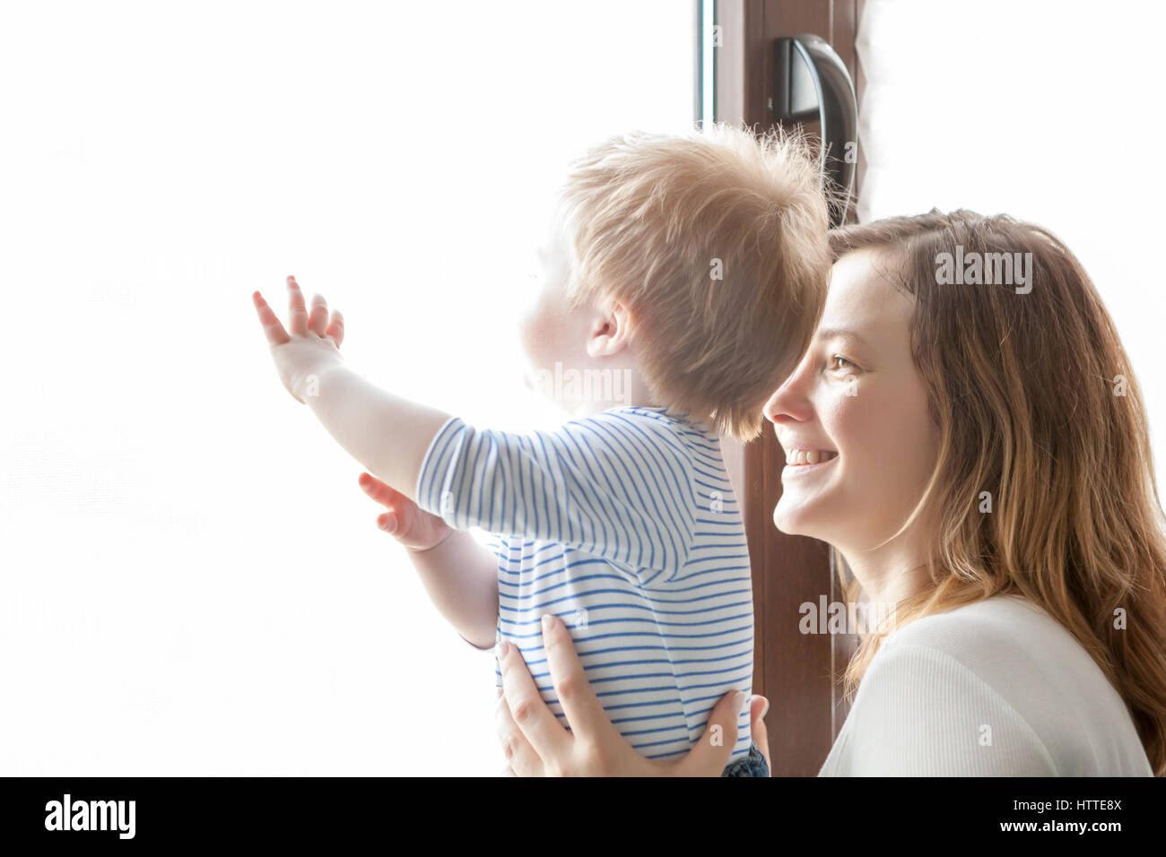 Mother and child at the window. Family lifestyle Stock Photo - Alamy