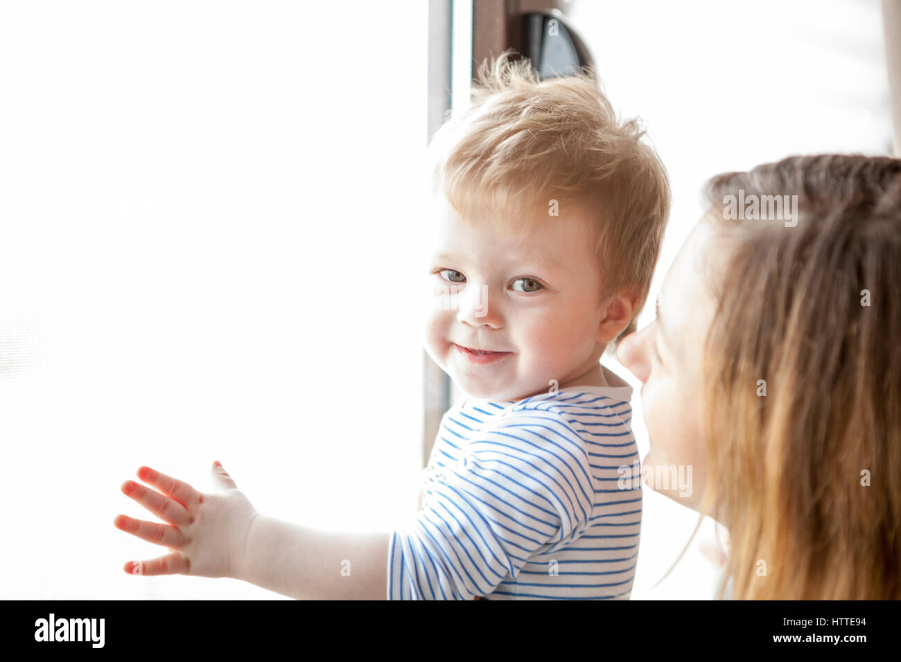 Mother and child at the window. Family lifestyle Stock Photo - Alamy