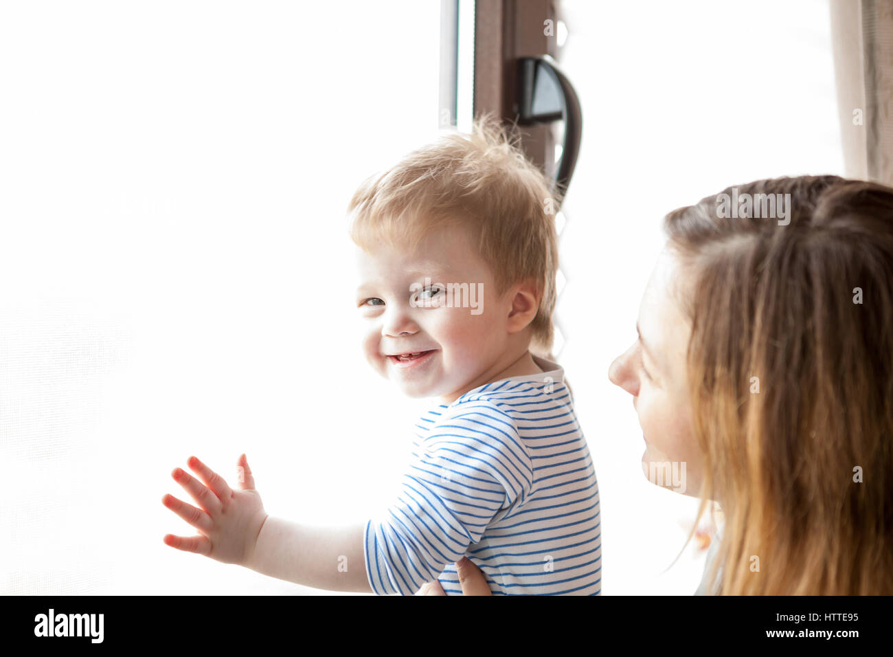 Mother and child at the window. Family lifestyle Stock Photo - Alamy