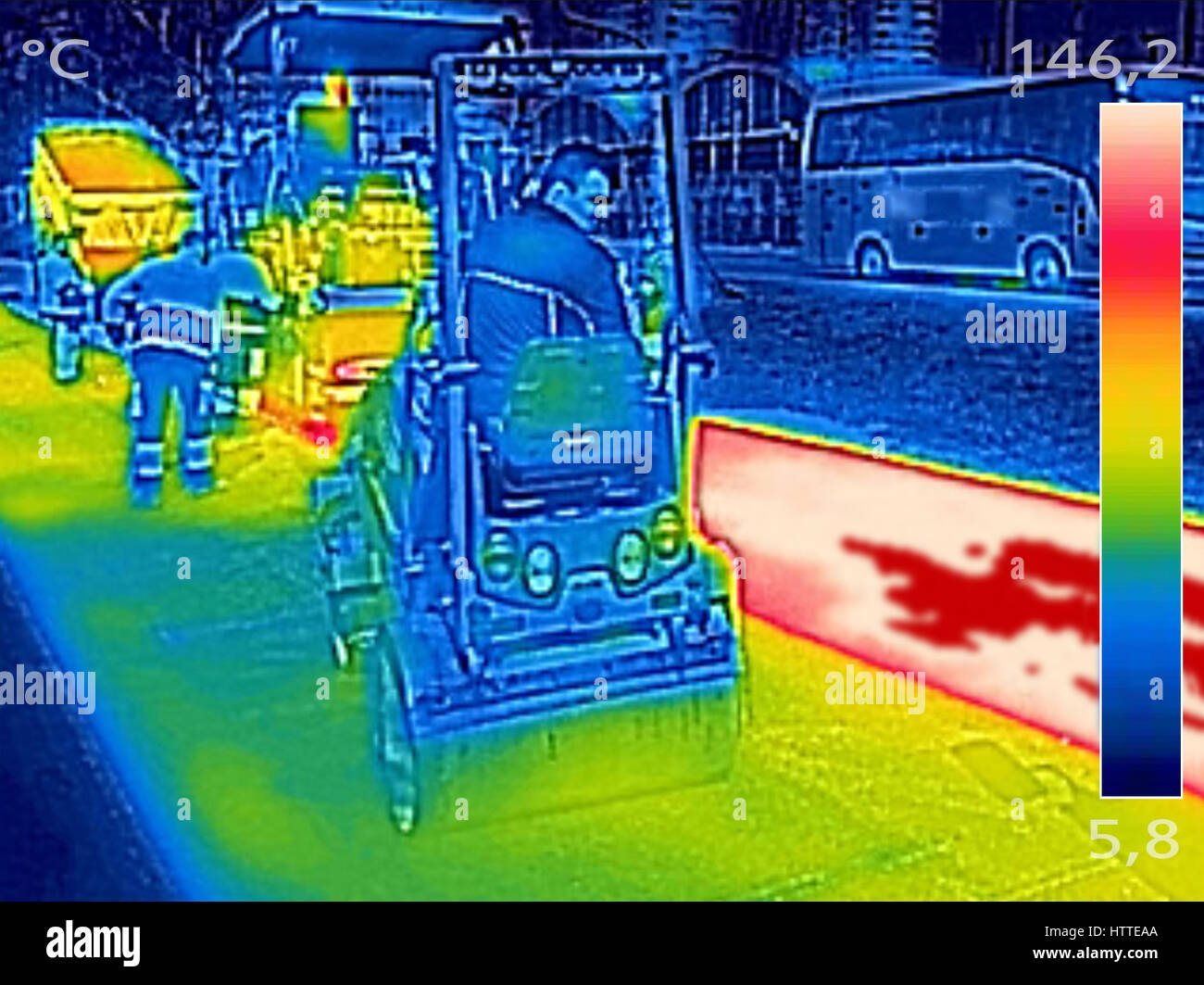 Infrared thermovision image showing Workers on Asphalting paver machine ...