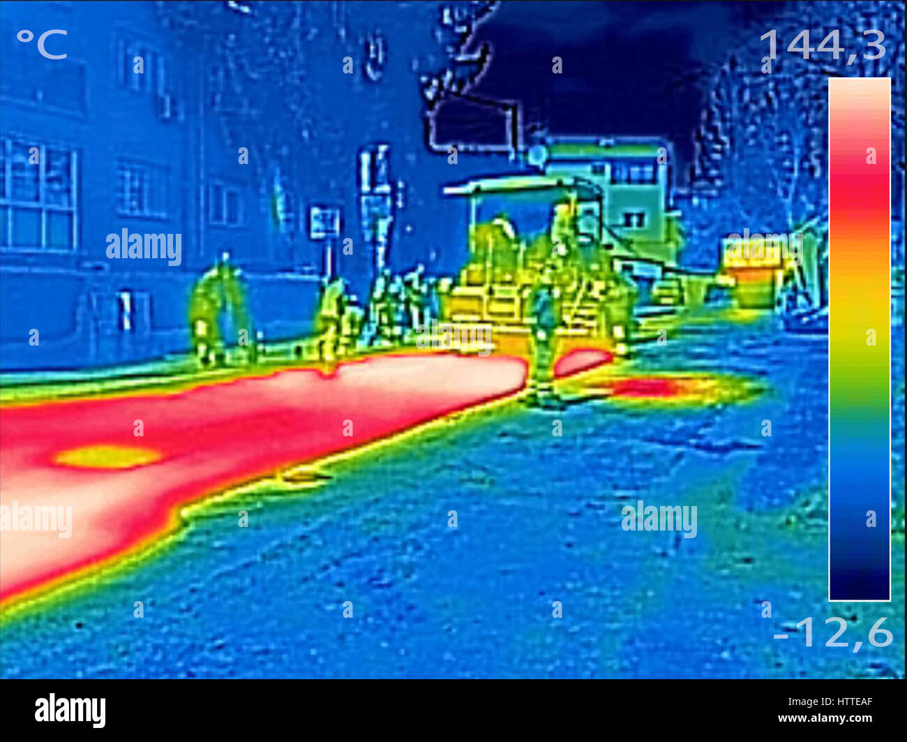 Infrared thermovision image showing Workers on Asphalting paver machine ...