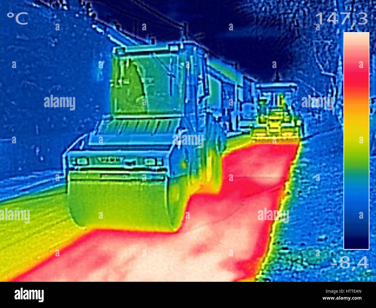 Infrared thermovision image showing Workers on Asphalting paver machine ...