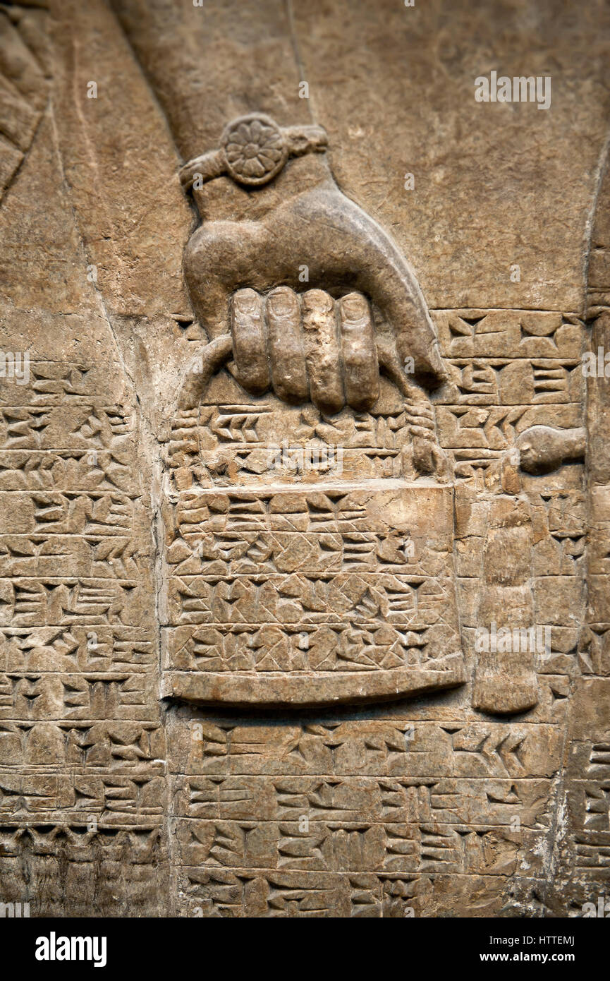 Assyrian relief sculpture panel detail of a hand holding a bucket of ...