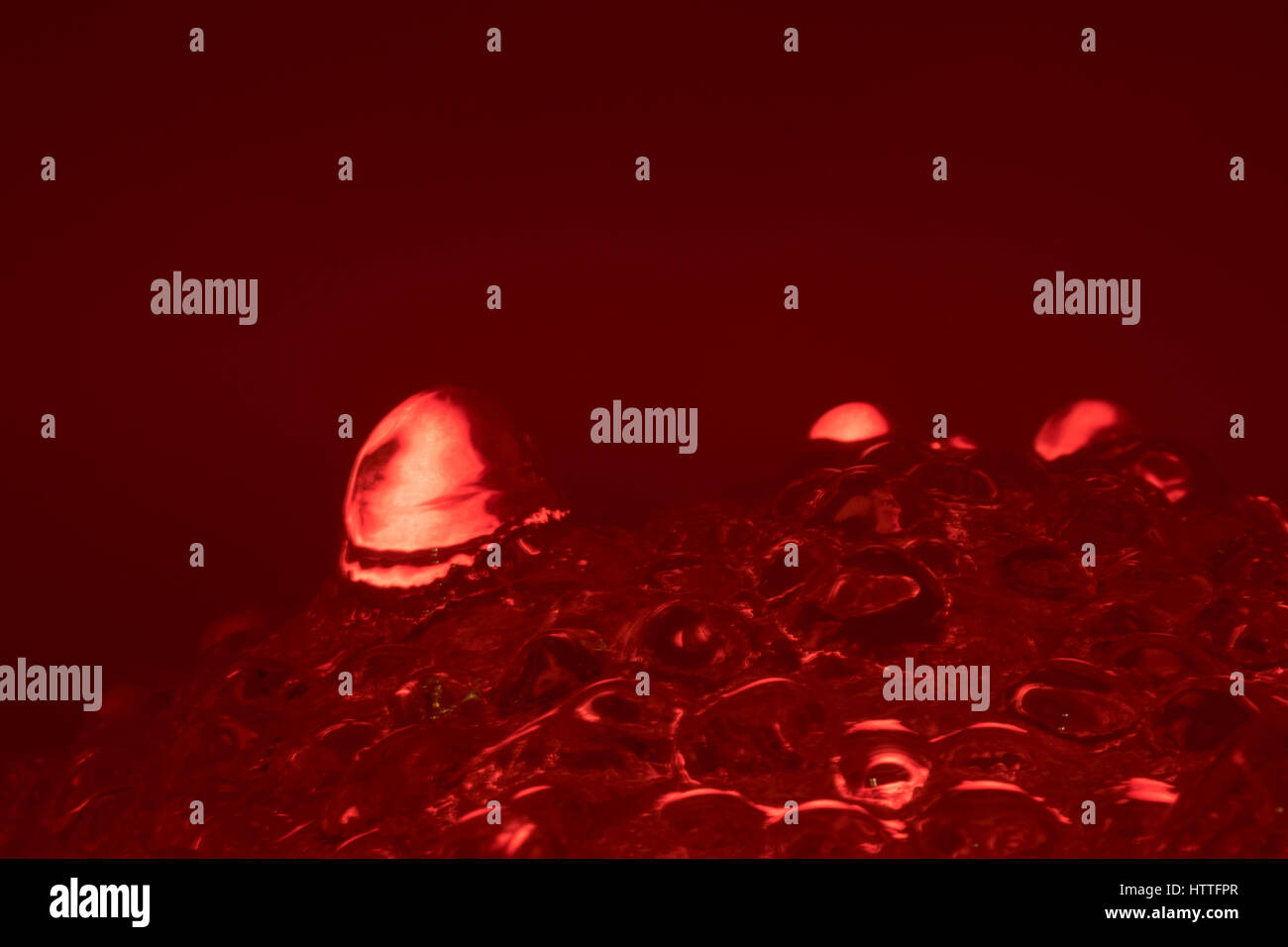 Red Bubbly Glass Stock Photo - Alamy