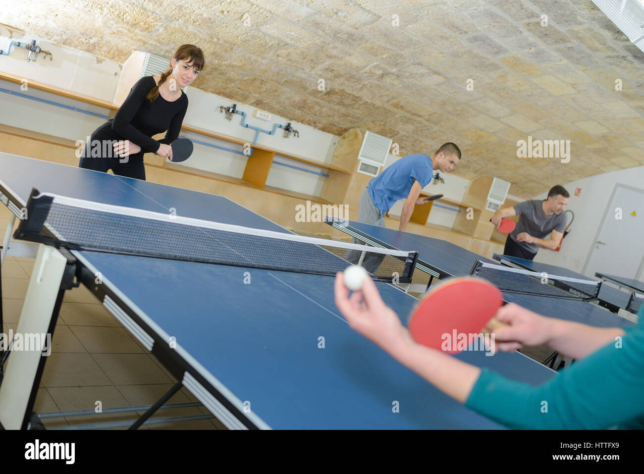 pretty woman playing ping-pong with friends Stock Photo - Alamy