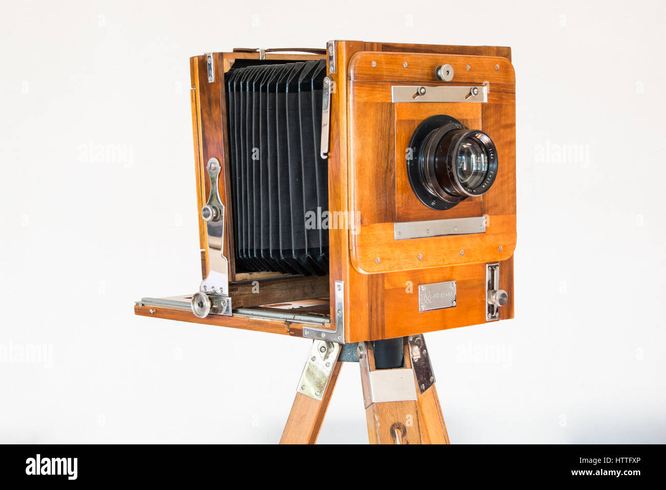 Old big vintage camera of wood and metal close on white background ...