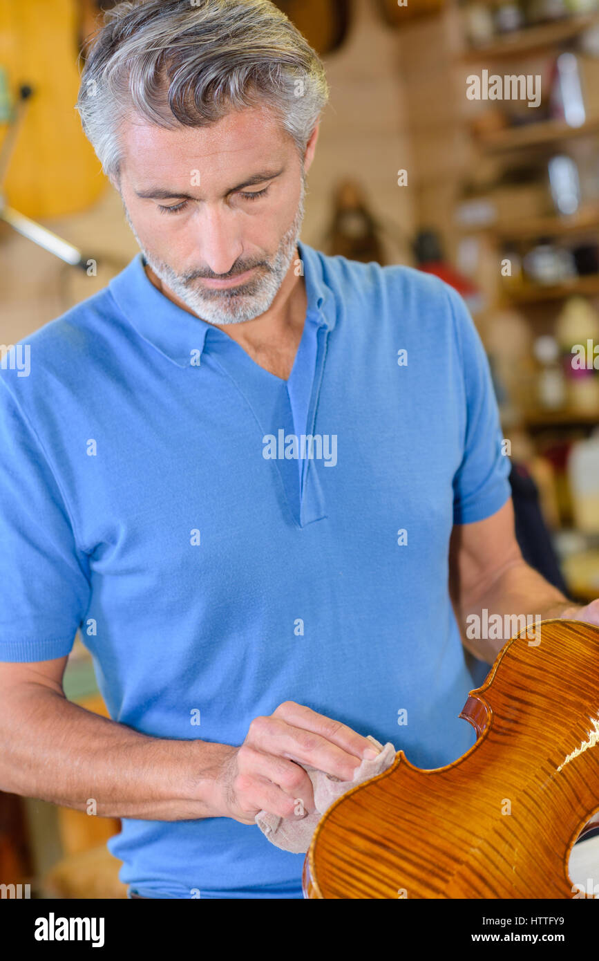 Man polishing violin Stock Photo - Alamy