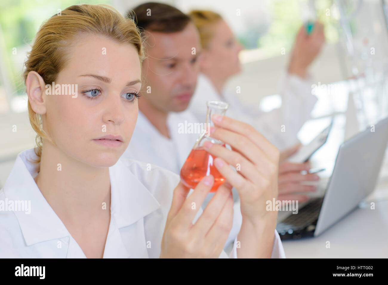 lab technician checking solutions Stock Photo - Alamy