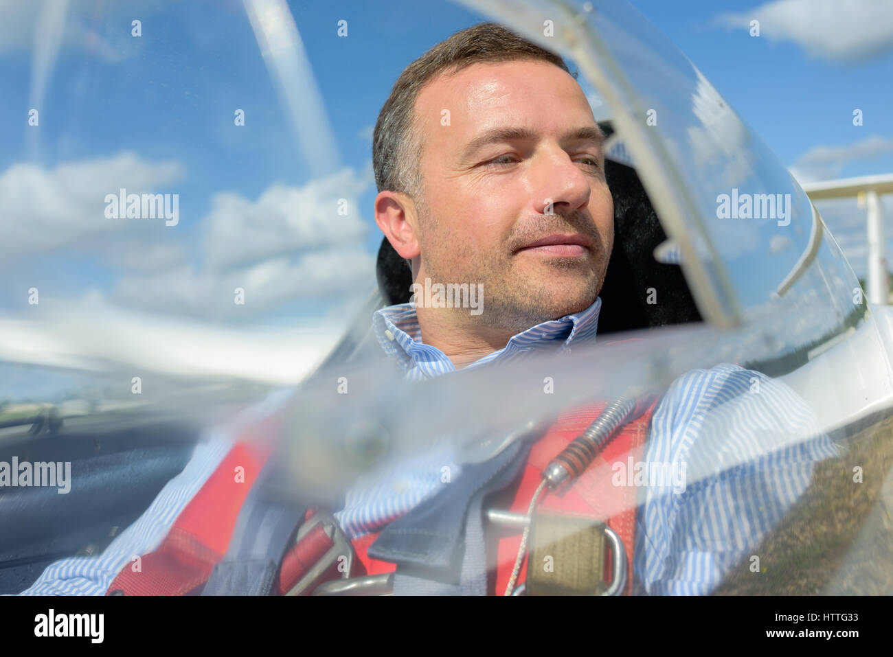 Man looking sideways out of glider Stock Photo - Alamy