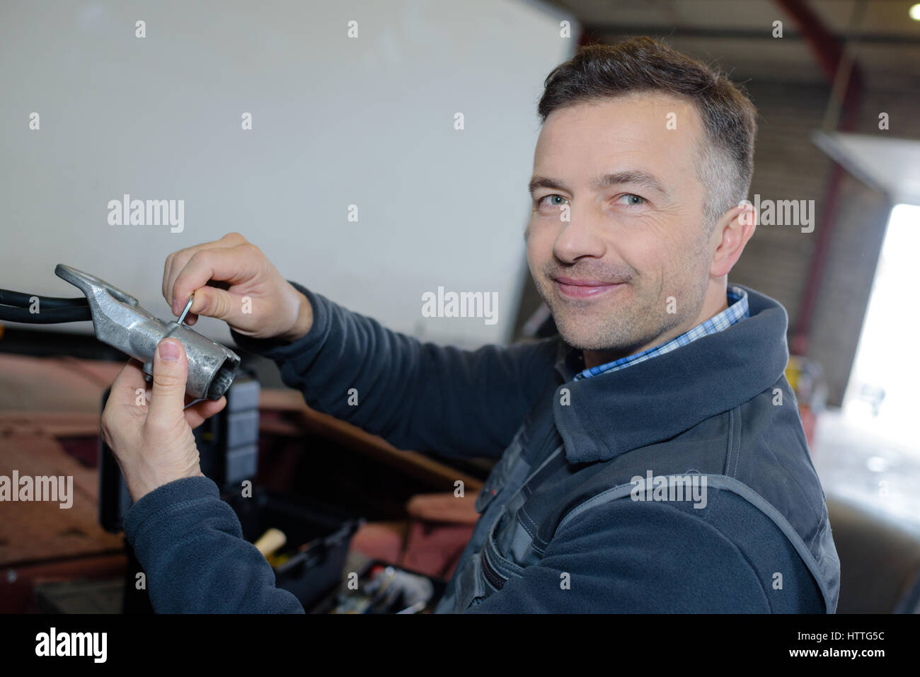 mechanician at work in the auto repair garage Stock Photo - Alamy