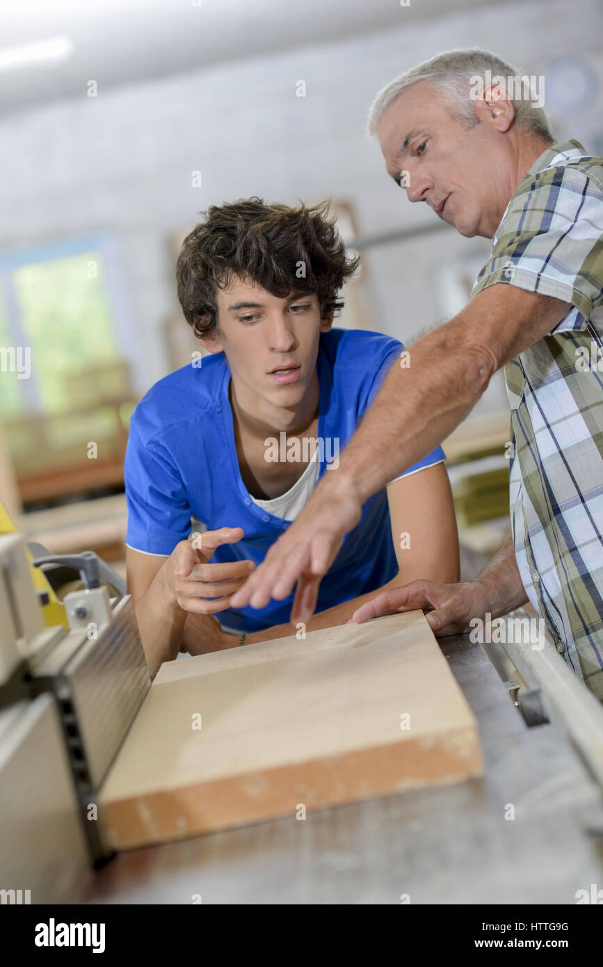 Carpenters using a band saw Stock Photo - Alamy