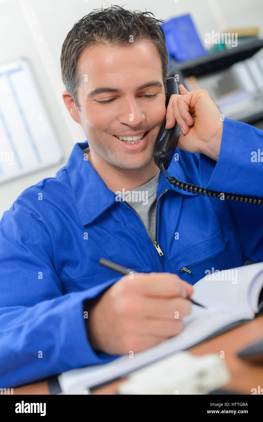 Builder on the phone Stock Photo - Alamy
