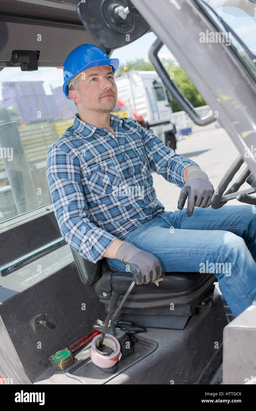 Man driving industrial machine Stock Photo - Alamy
