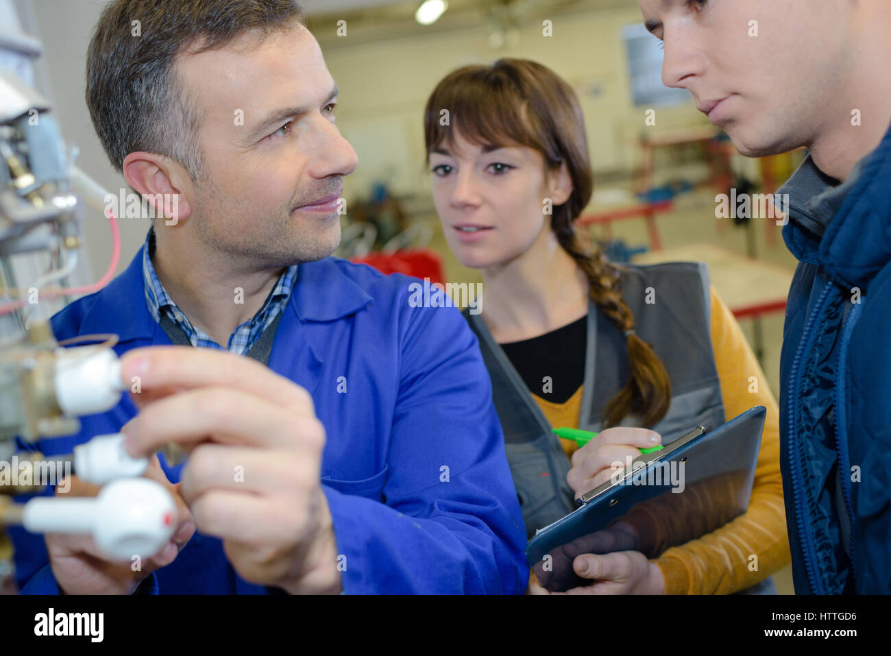 teachers and students checking machinery procedure Stock Photo - Alamy