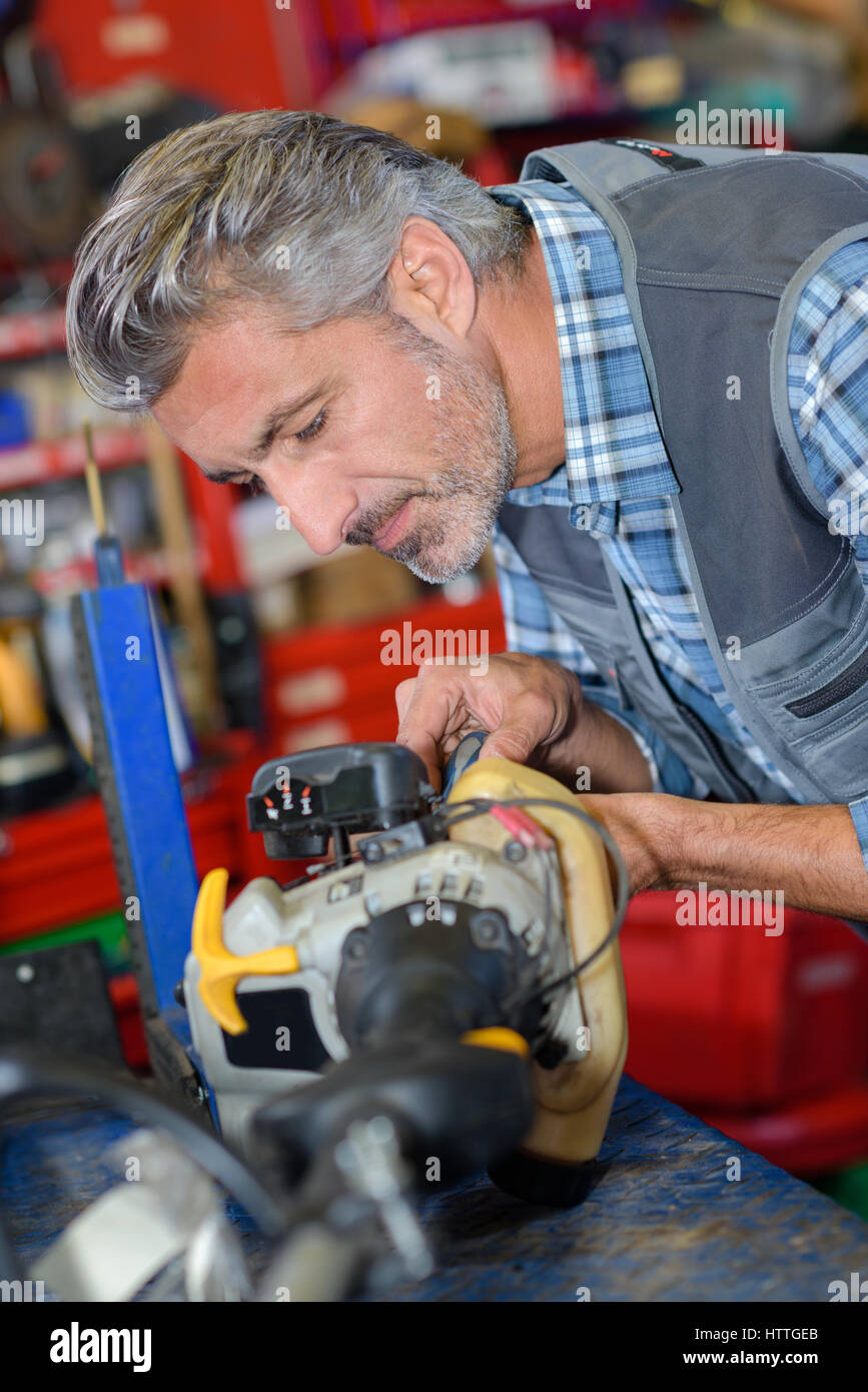 fixing a small equipment Stock Photo - Alamy