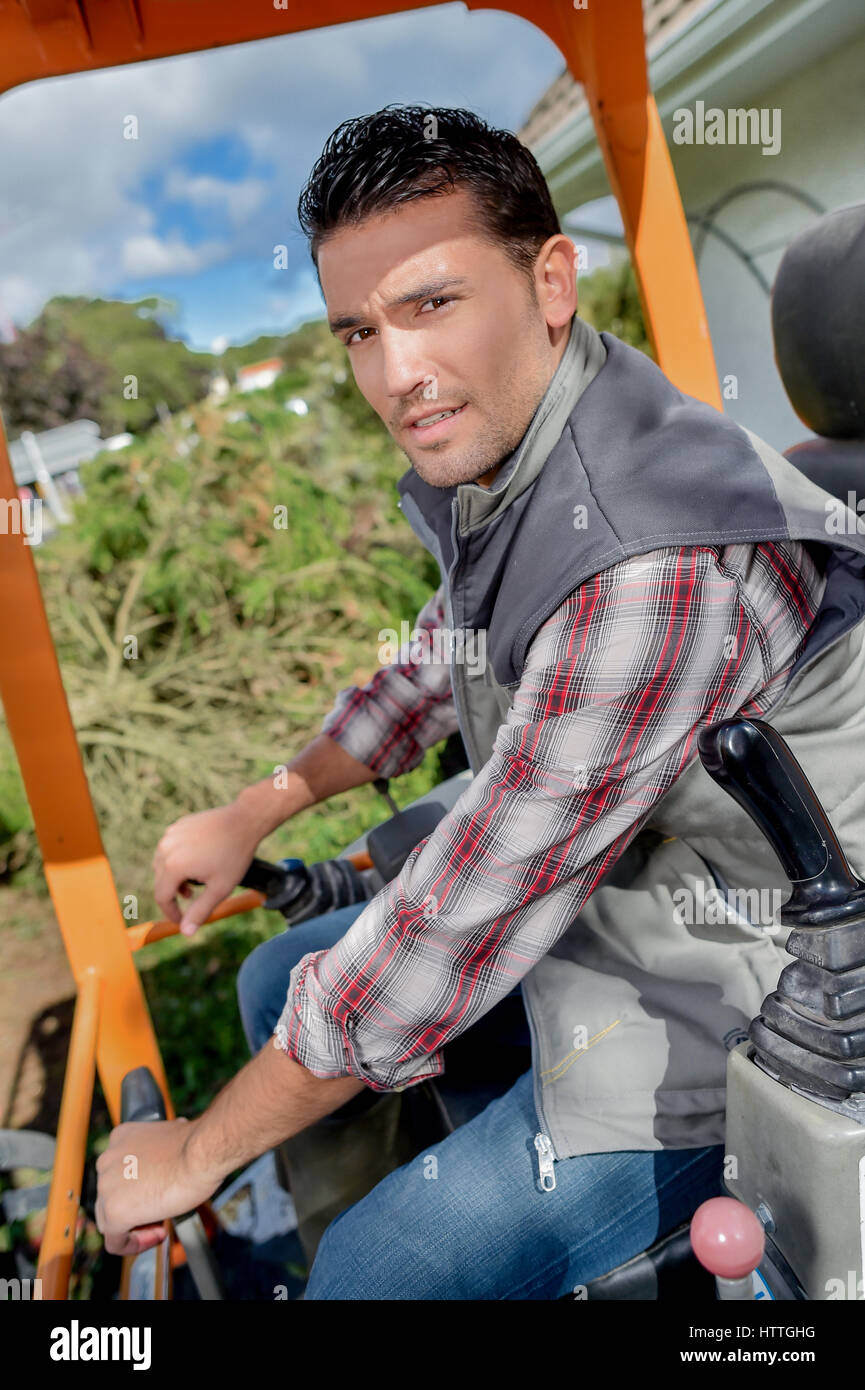 Man operating a digger Stock Photo - Alamy