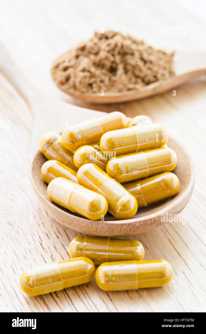 Herbal powder in capsule and wooden spoon Stock Photo - Alamy