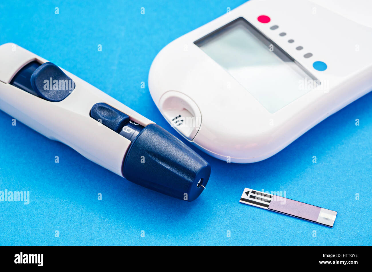blood glucose meter on blue background Stock Photo - Alamy