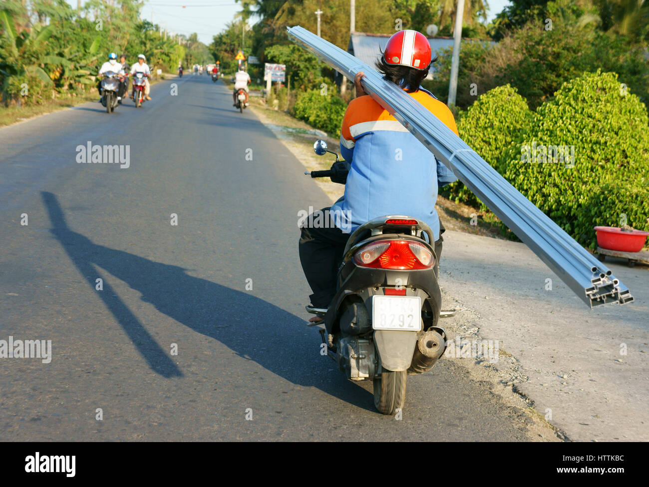 BEN TRE, VIET NAM- MAR 24: Transportation goods on street in danger by ...