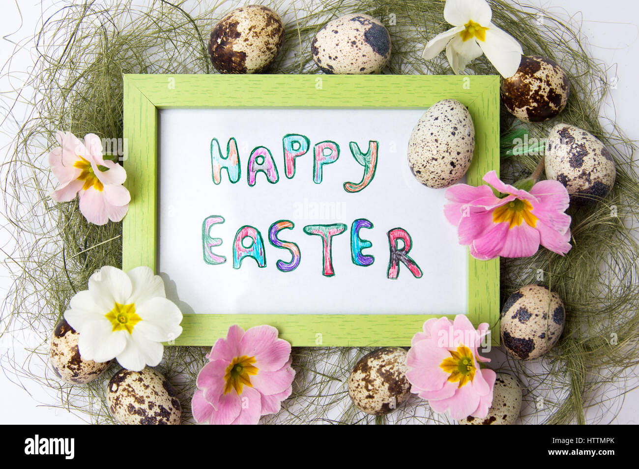 Happy Easter note in a frame with quail eggs in a nest Stock Photo - Alamy
