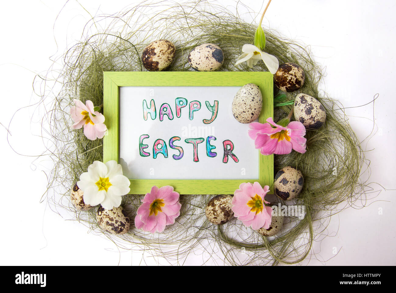 Happy Easter note in a frame with quail eggs in a nest Stock Photo - Alamy