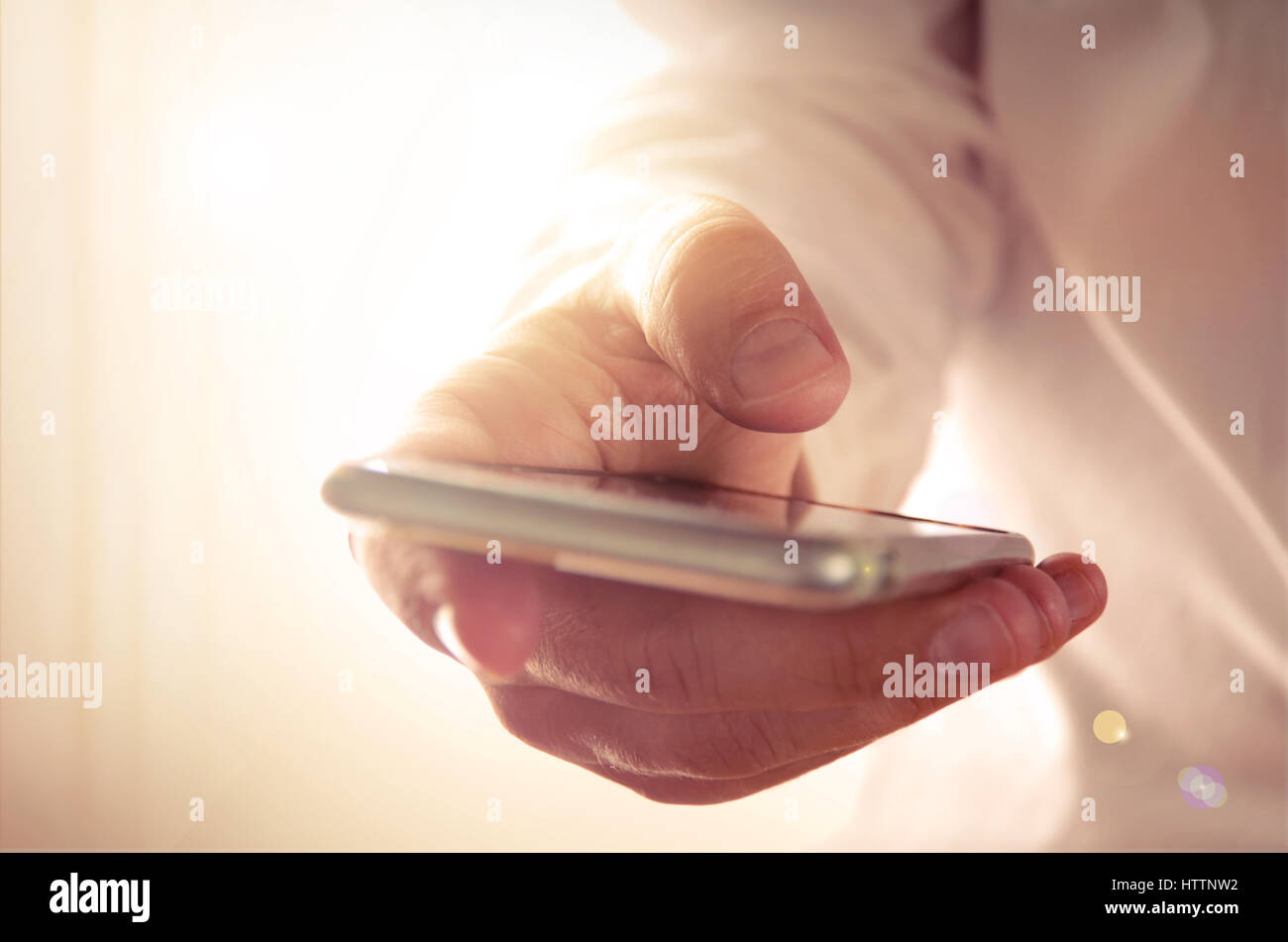 Man’s hand holding and using a smartphone. Concept for business and ...