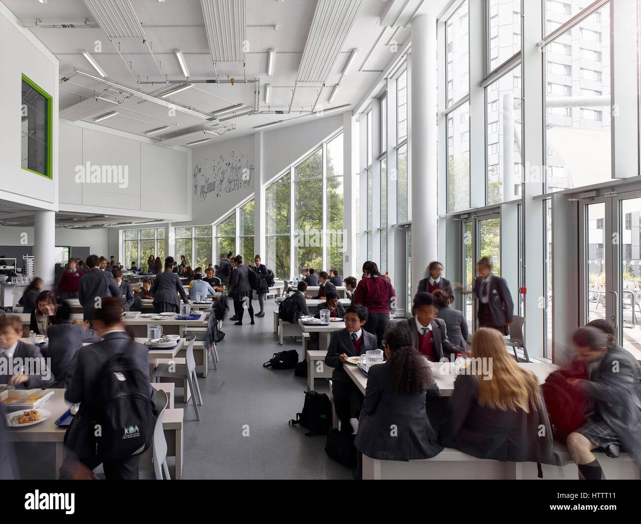 Dining hall in use at lunch time. Kensington Aldridge Academy, London ...