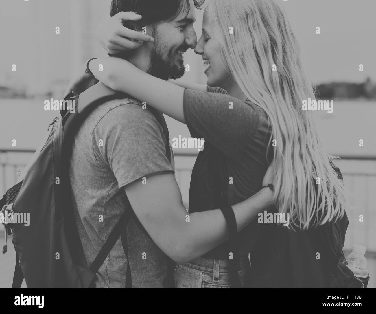 Couple staring at each other city background Stock Photo - Alamy