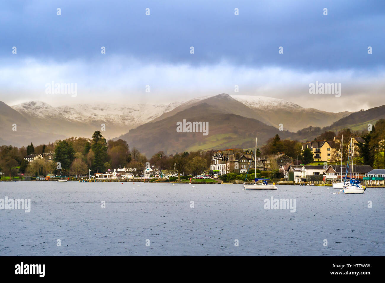 Ambleside mist from lake Windermere with snow capped mountains Stock ...