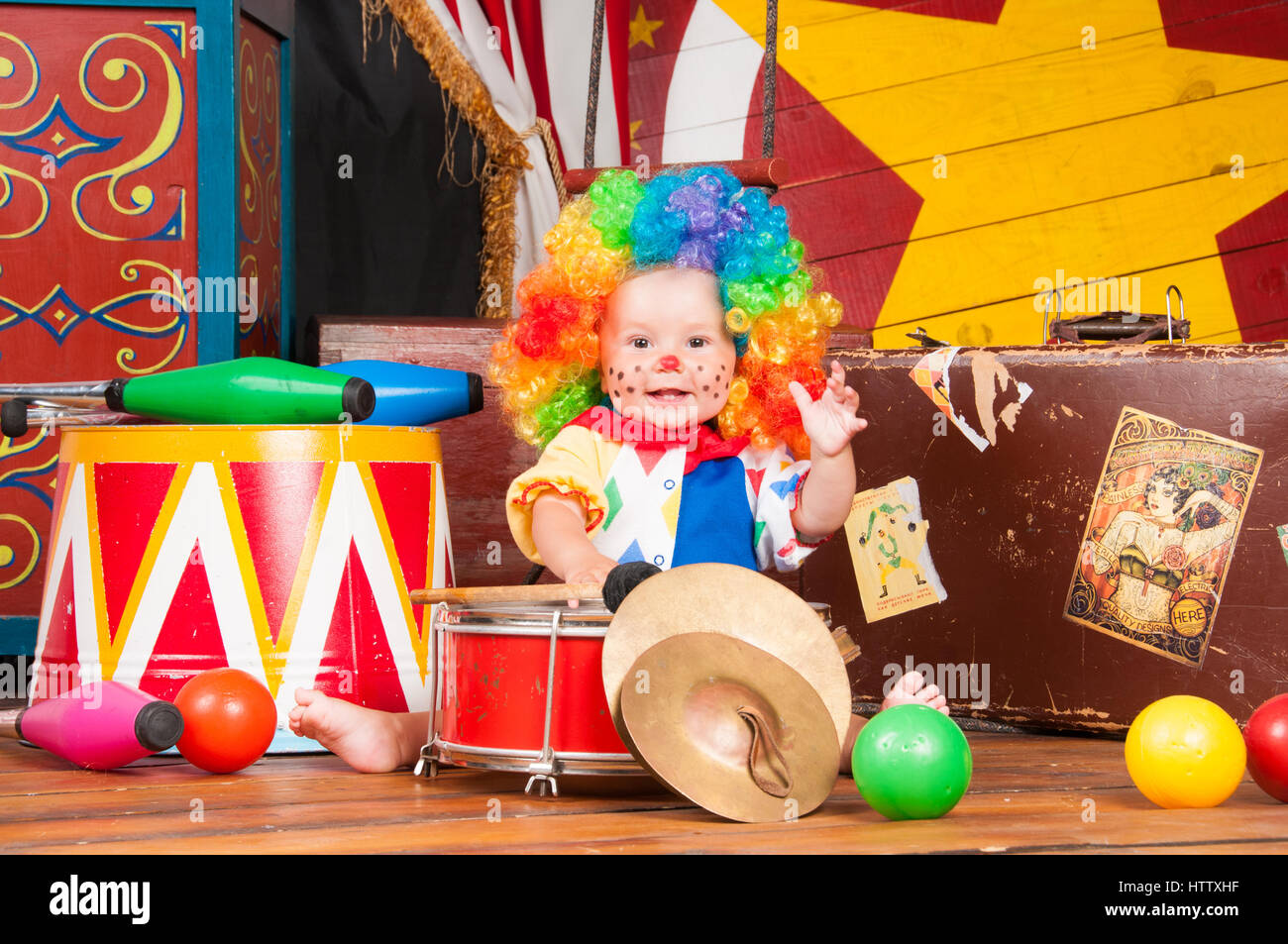 Little baby clown with red nose multi-colored wig in with balls Stock ...