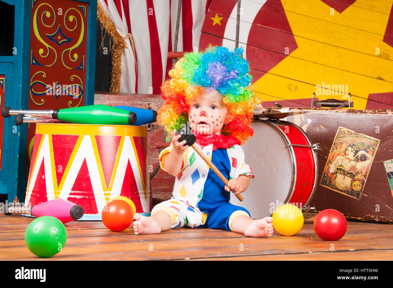 Little baby clown with red nose multi-colored wig in with balls Stock ...