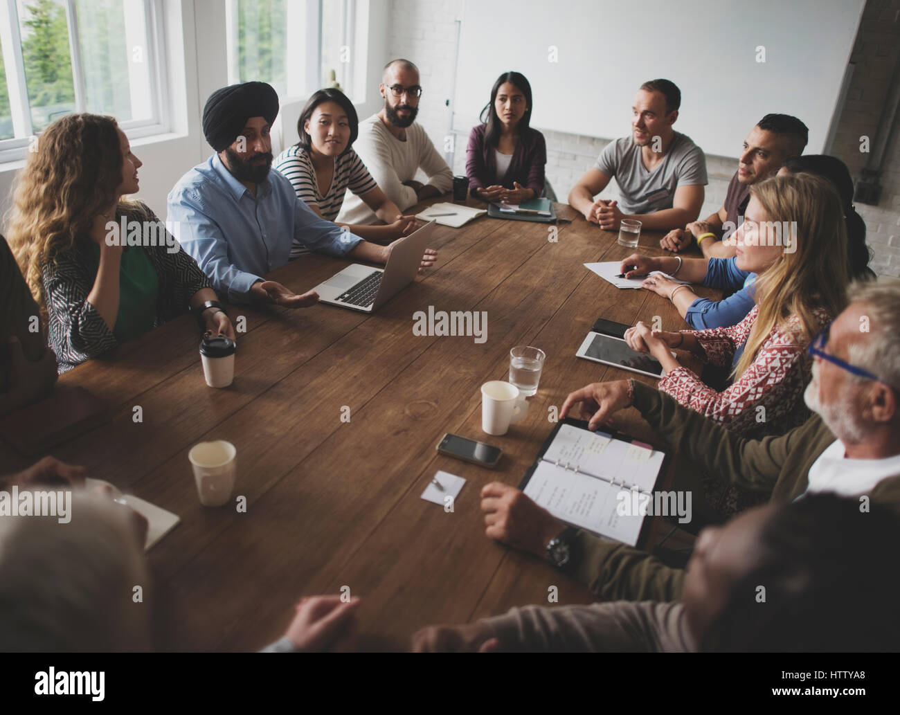 Diverse people teamwork on meeting table Stock Photo - Alamy